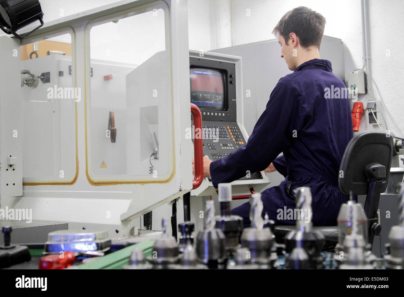 Germany, Young mechanic working in crafts workshop Stock Photo - Alamy