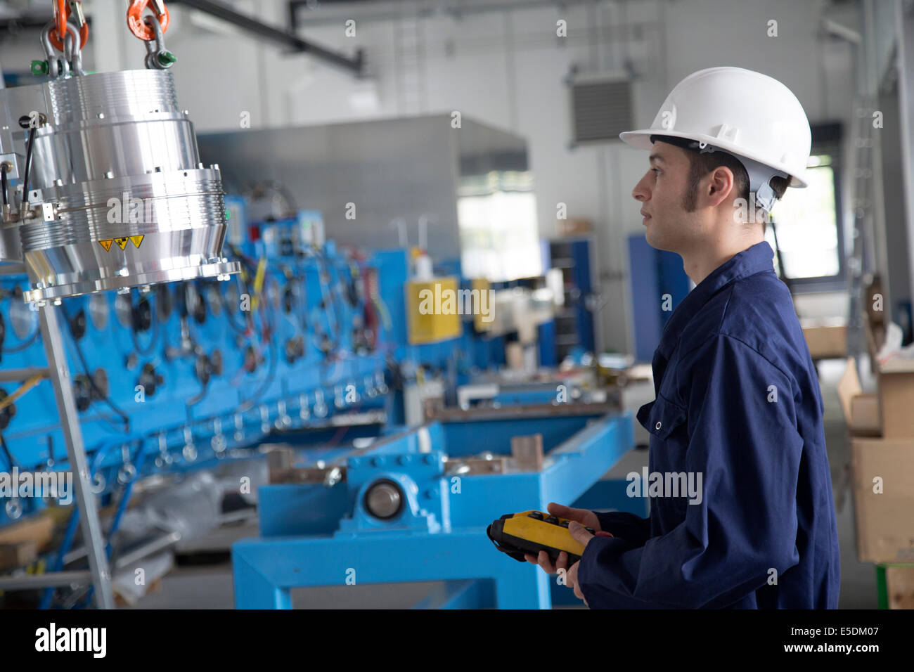 Technician in a factory building Stock Photo - Alamy