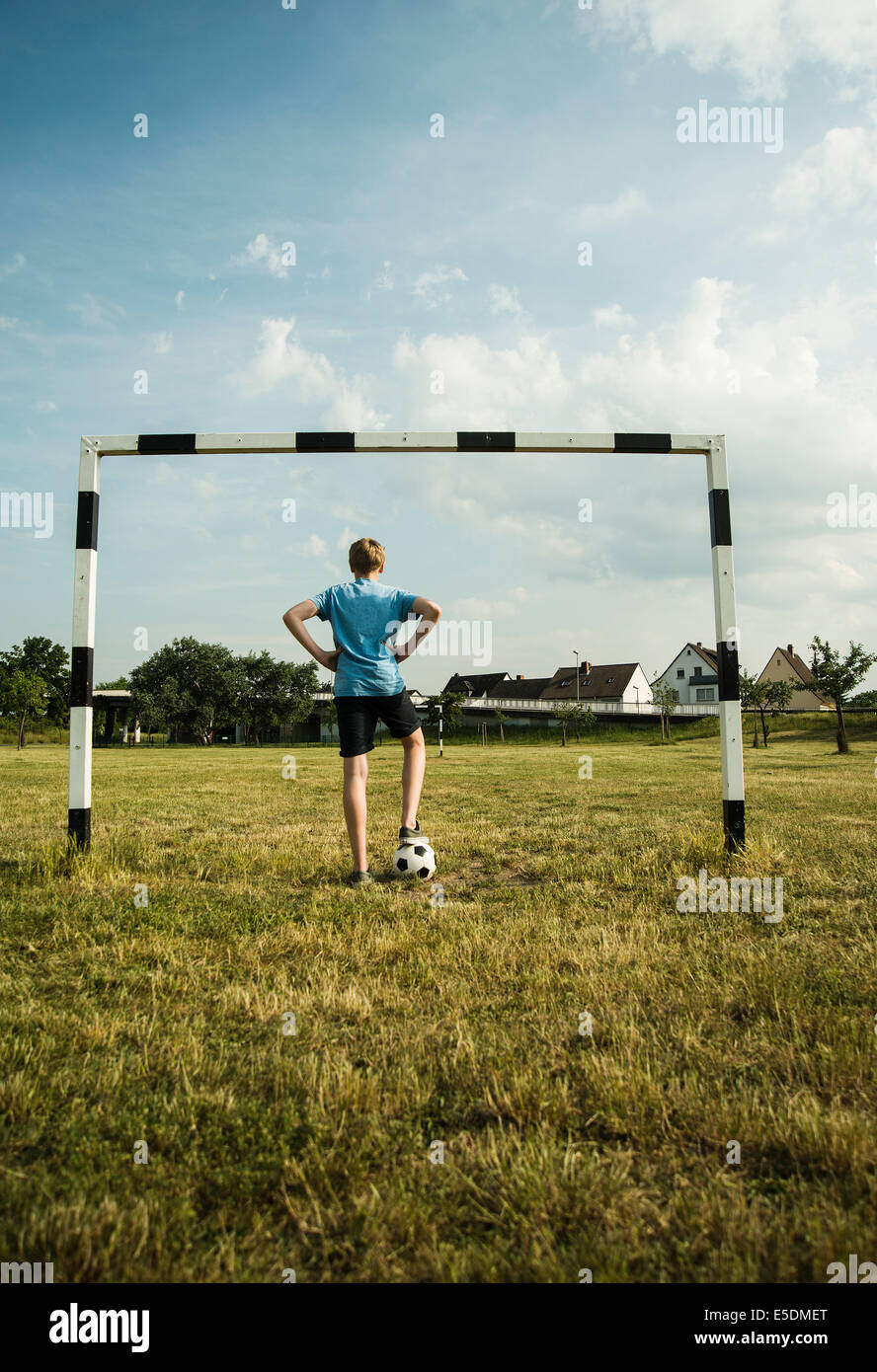 Germany, Mannheim, Teenage boy standing in goal, hands on hips Stock ...
