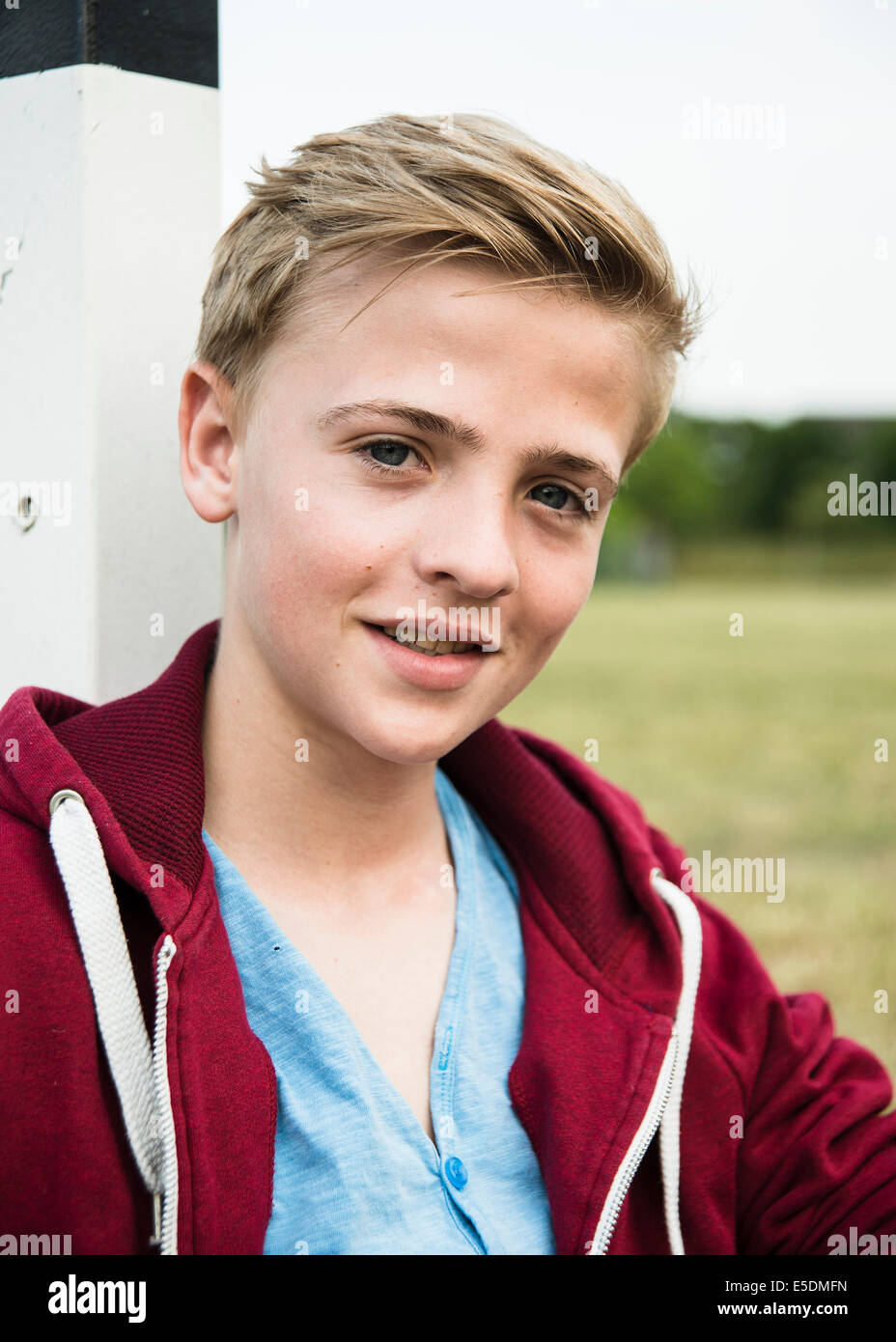 Germany, Mannheim, Teenage boy leaning on goal post Stock Photo - Alamy
