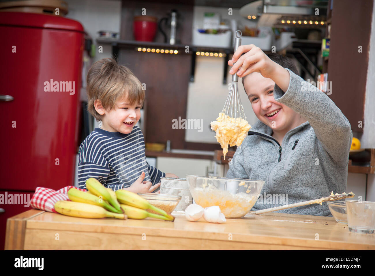Two brothers baking a cake together at home Stock Photo - Alamy