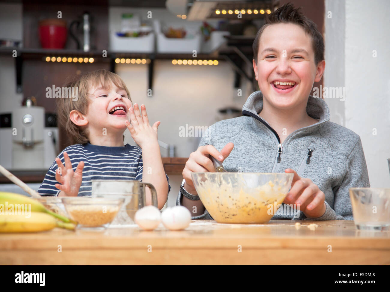 Two brothers baking a cake together at home Stock Photo - Alamy