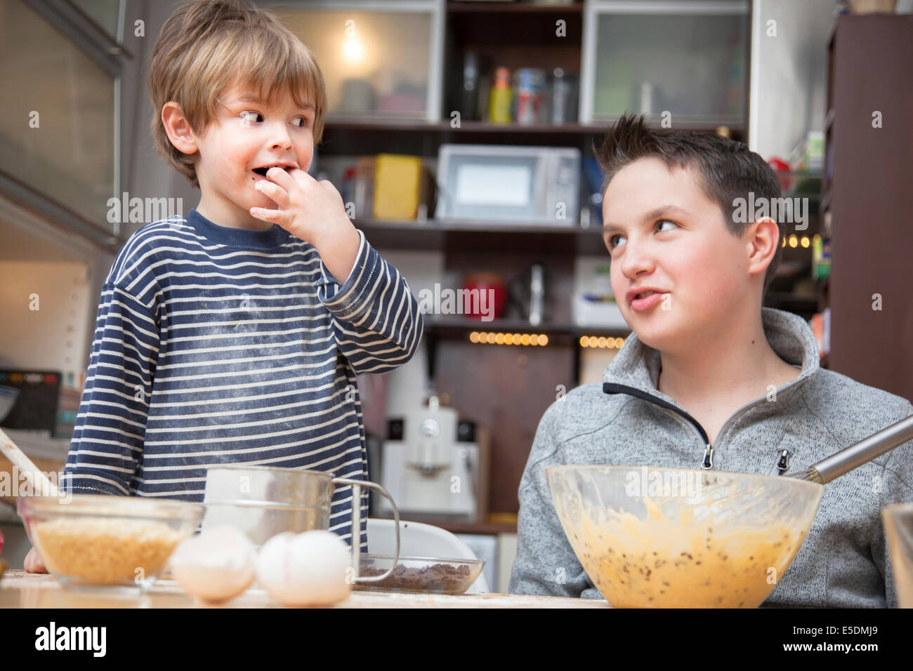 Two brothers baking a cake together at home Stock Photo - Alamy