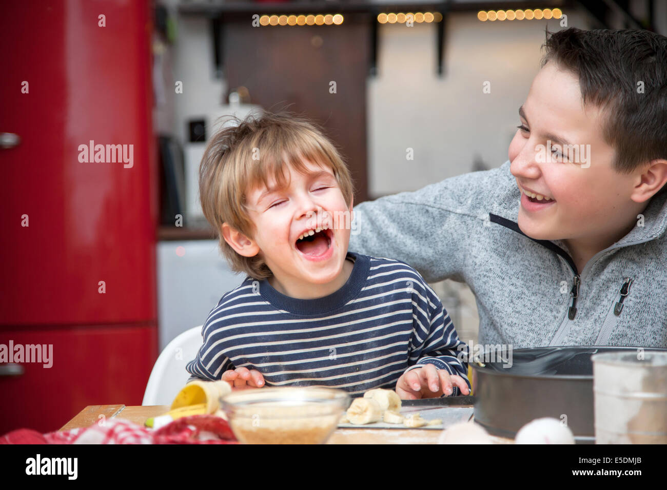 Two brothers baking a cake together at home Stock Photo - Alamy