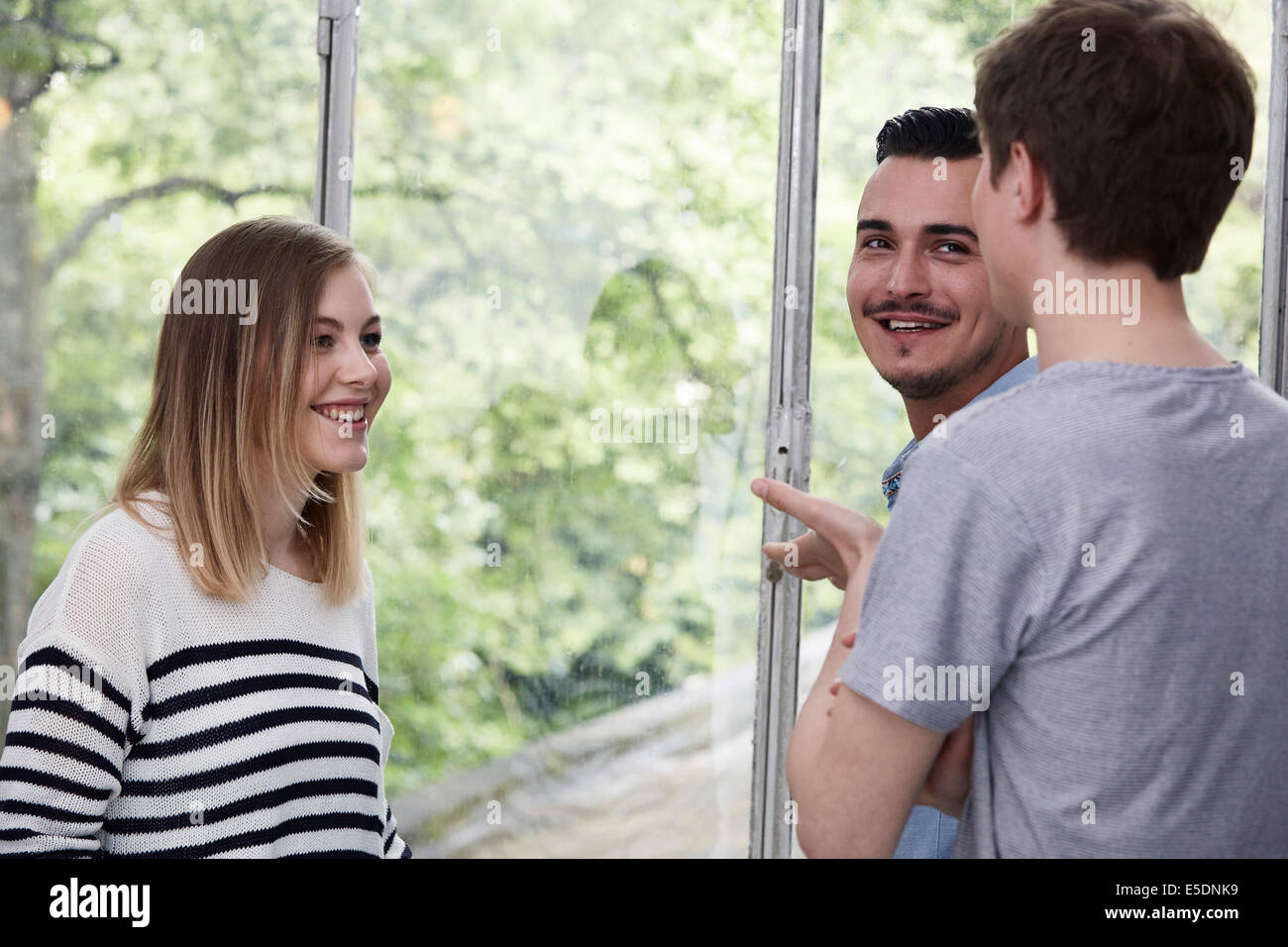 Colleagues talking at a window Stock Photo - Alamy