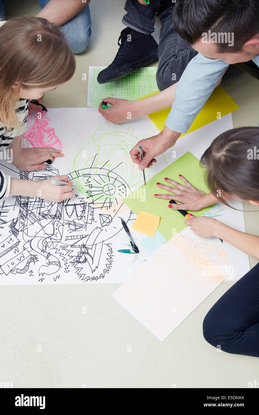 Creative professionals drawing on paper Stock Photo - Alamy