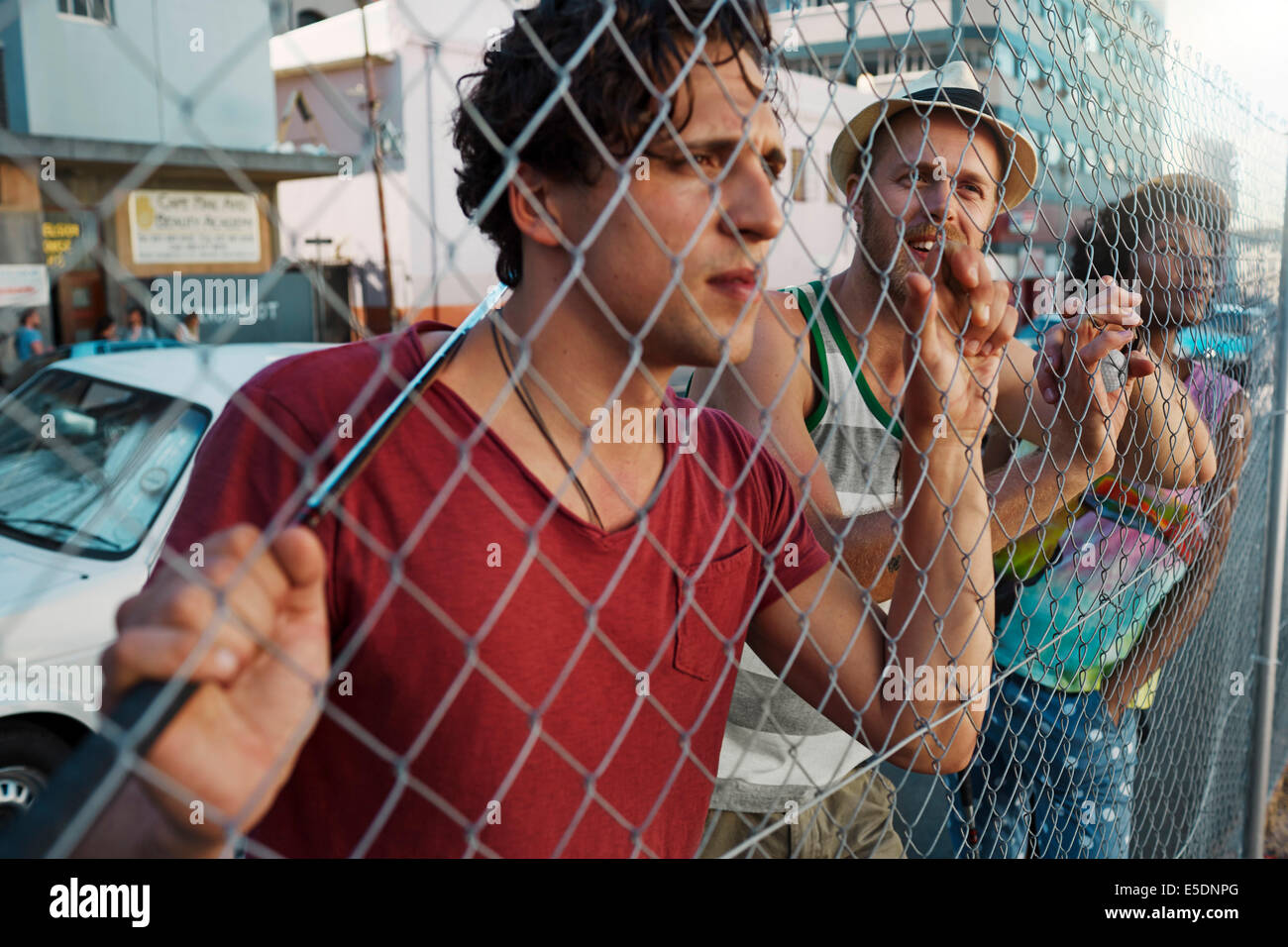 Group of people standing behind fence hi-res stock photography and ...