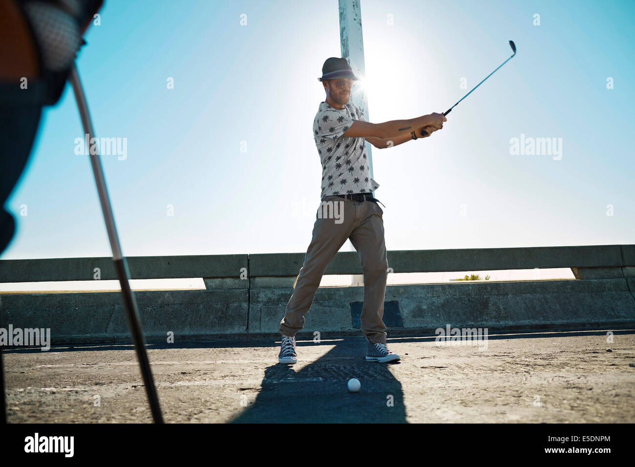 Man playing golf road hi-res stock photography and images - Alamy