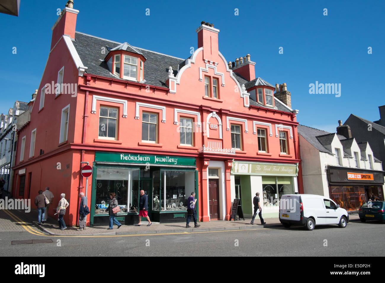 Jewelry and food shop in orange terracotta colour in bright sunny day ...