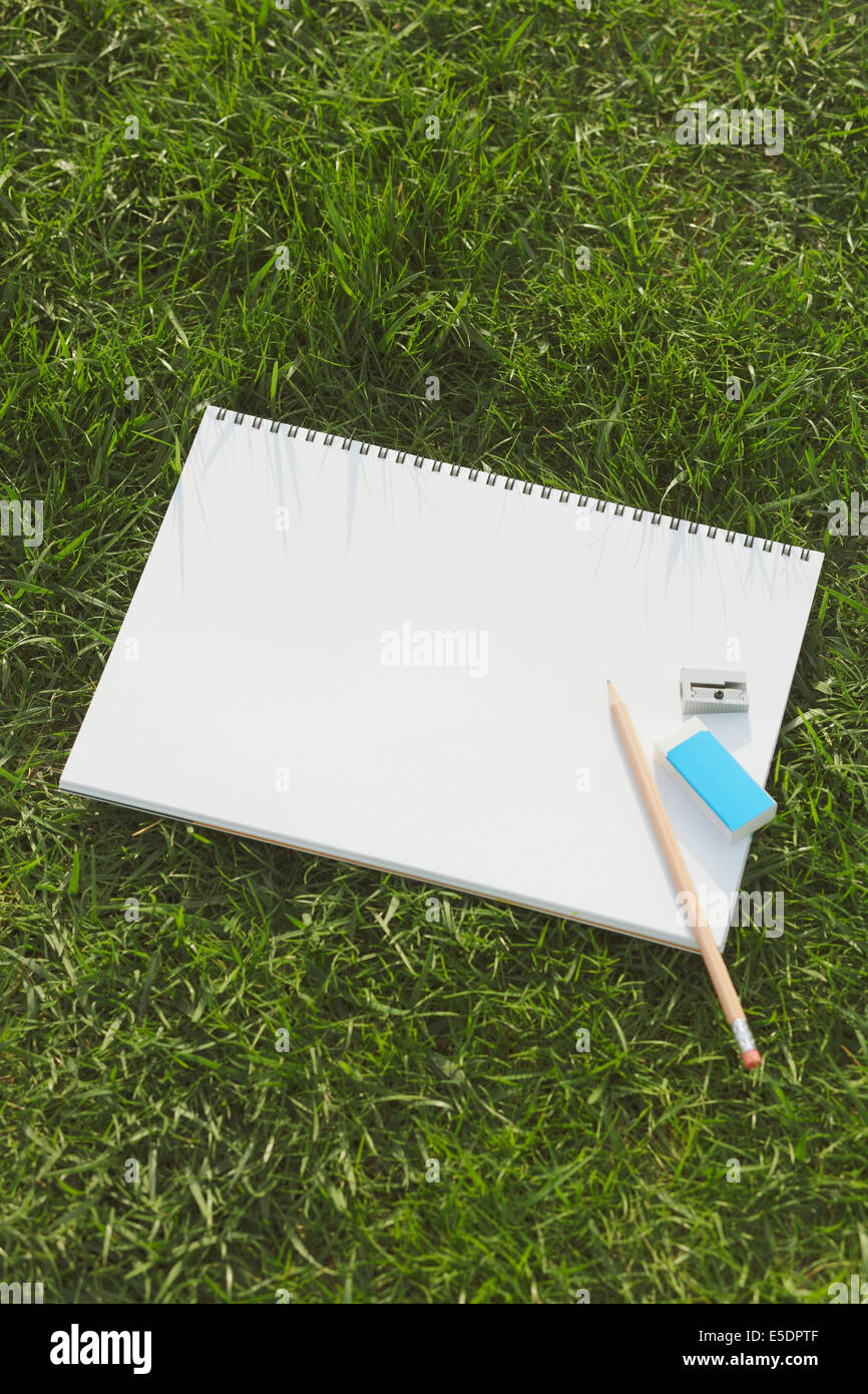 Pencil and sketchbook on grass Stock Photo - Alamy