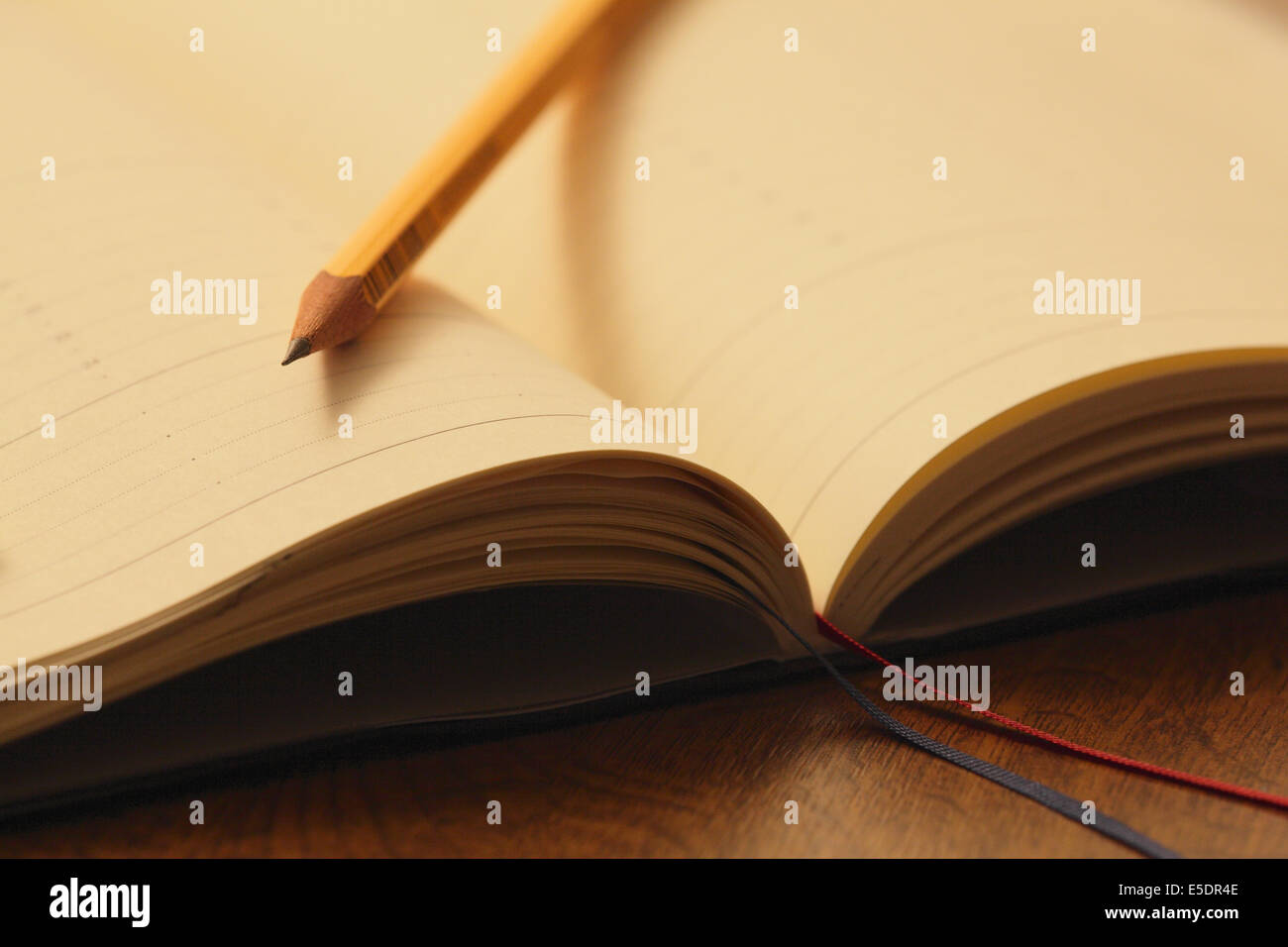 Notebook and pencil Stock Photo - Alamy