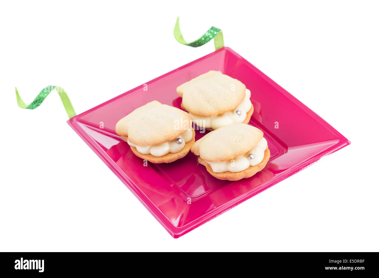 Shell shaped cookies with buttercream and pearl candy isolated on white ...