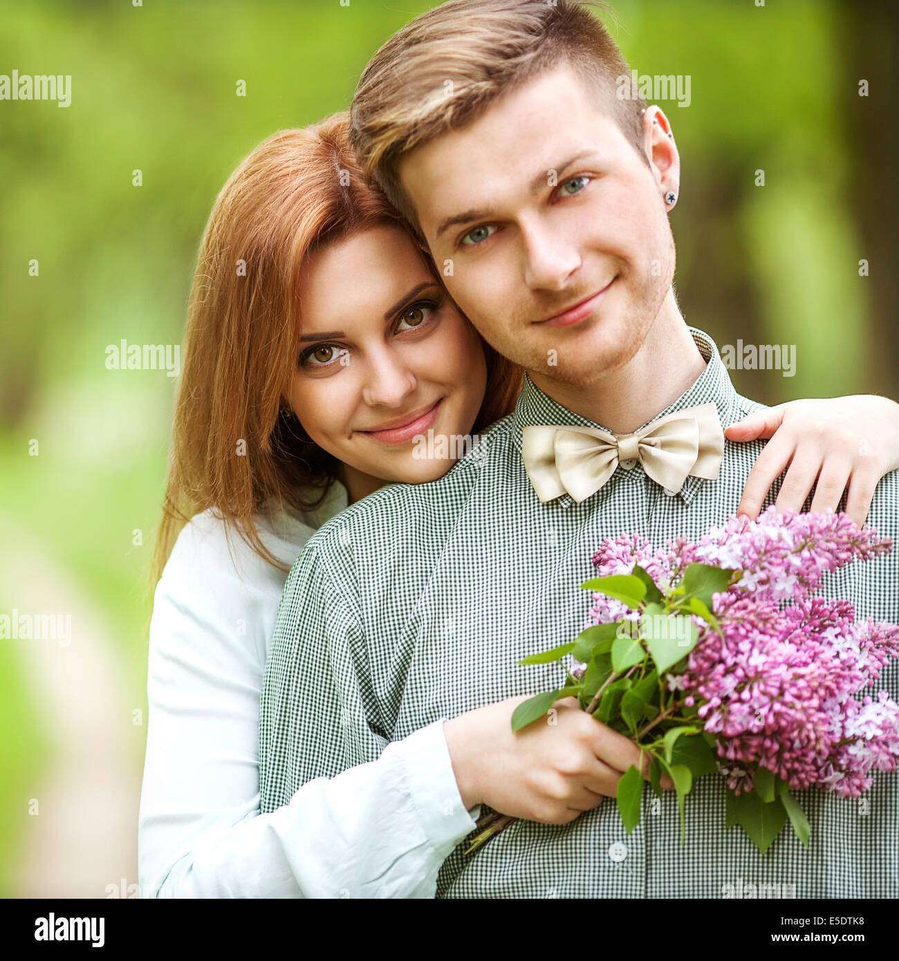 couple in love in blooming apple trees garden, smiling . Valentine's ...