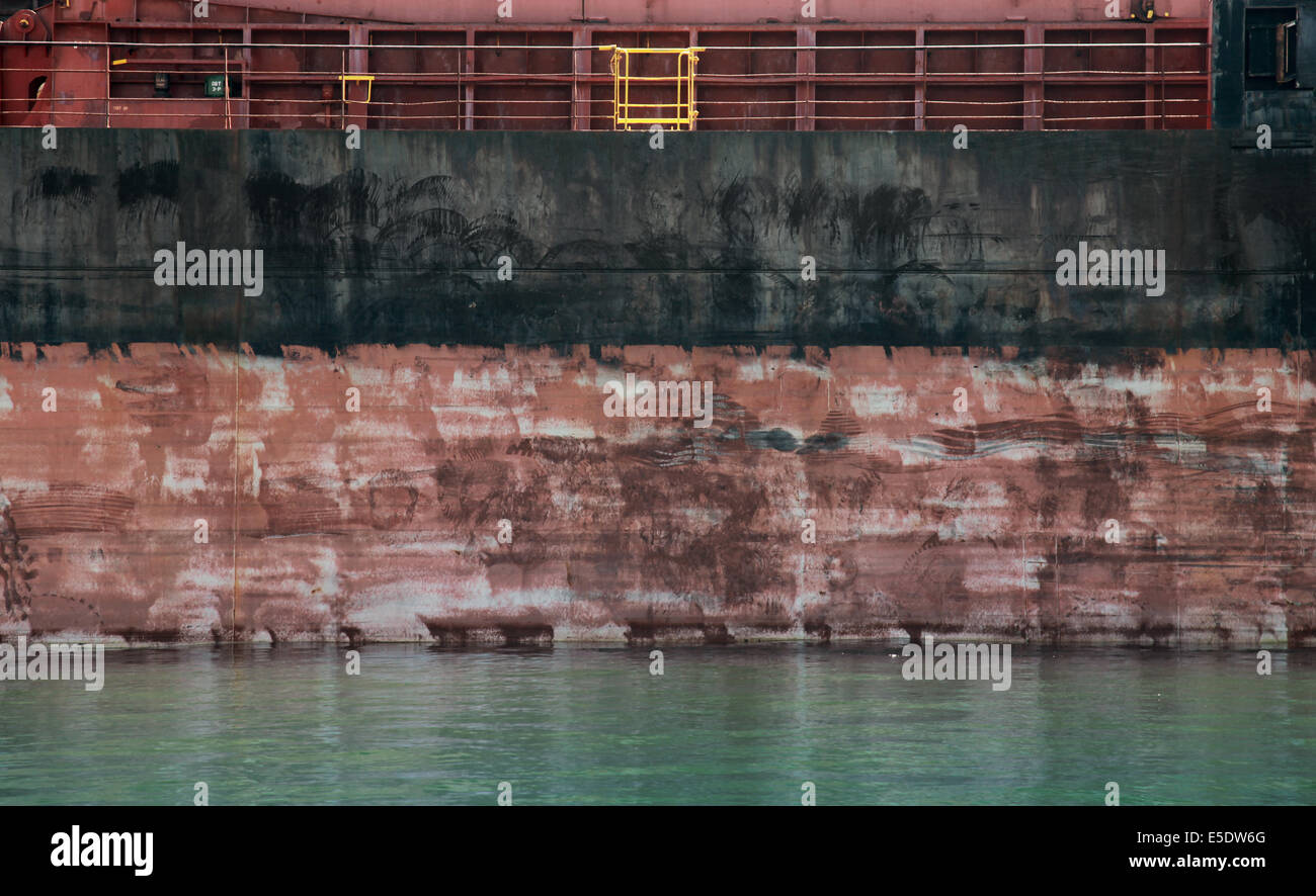 Black and red cargo ship hull side texture and water Stock Photo - Alamy