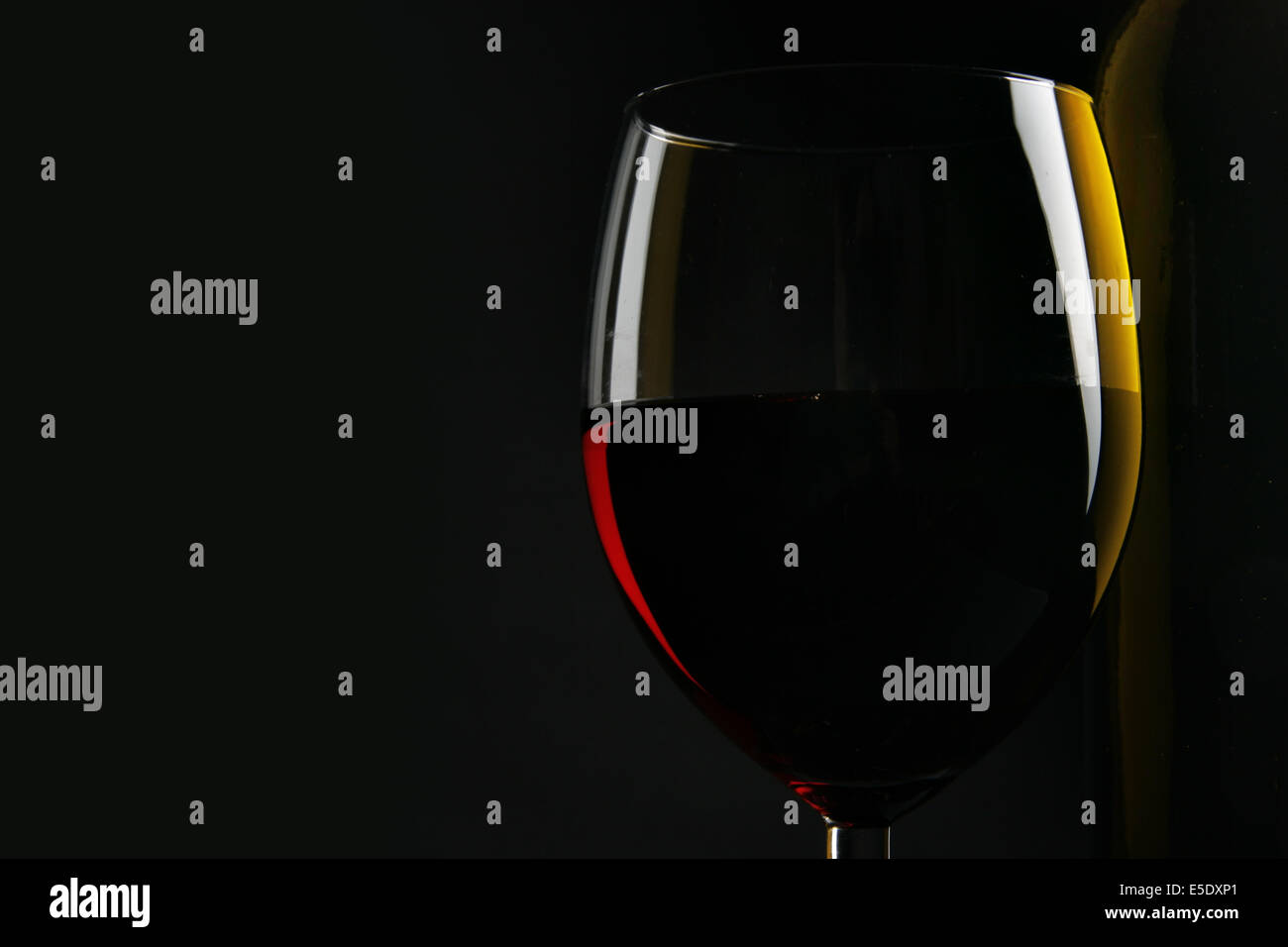 Still-life with glass of red wine over black background Stock Photo - Alamy