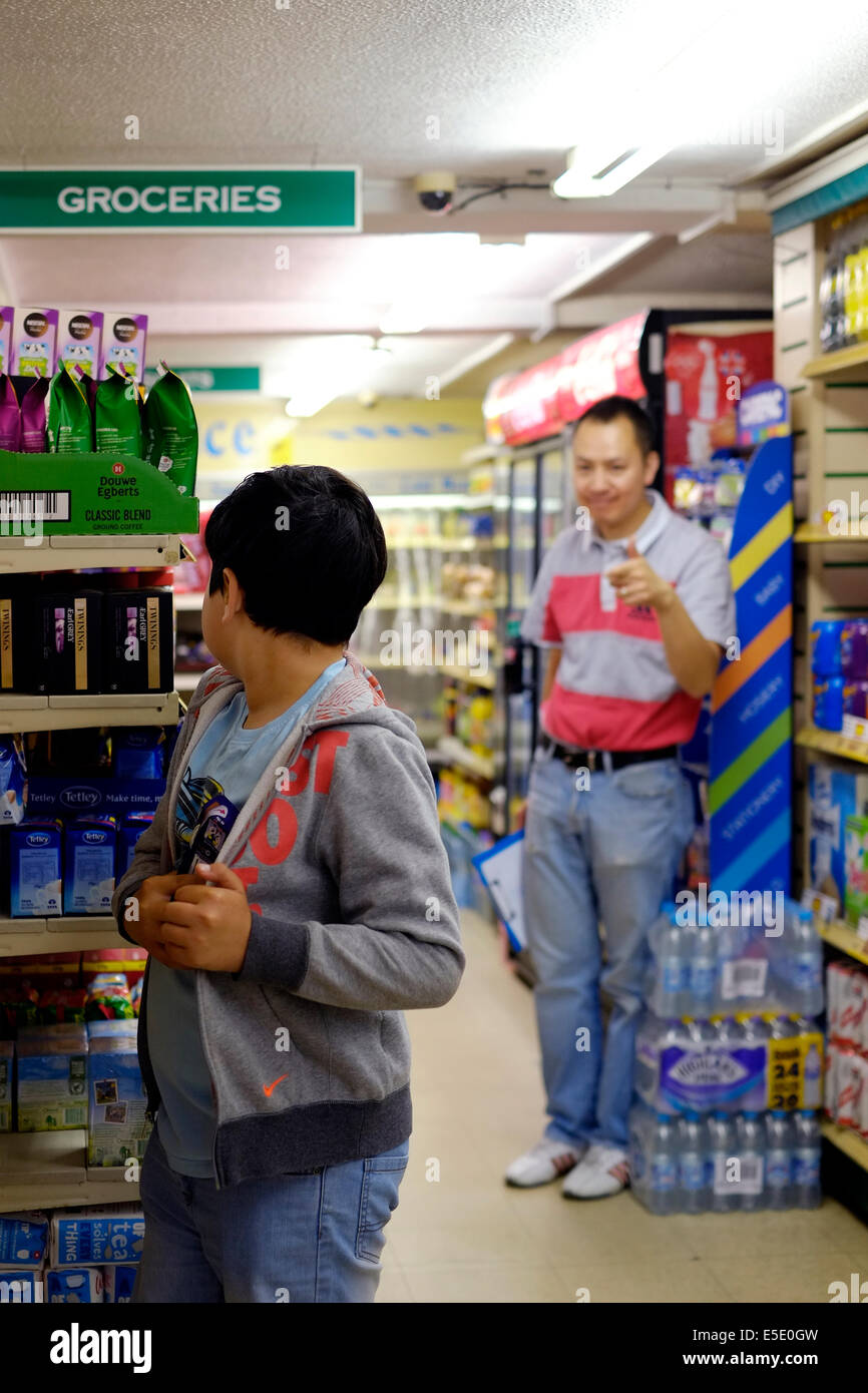 young boy shoplifting sweets in a small mini market Stock Photo - Alamy