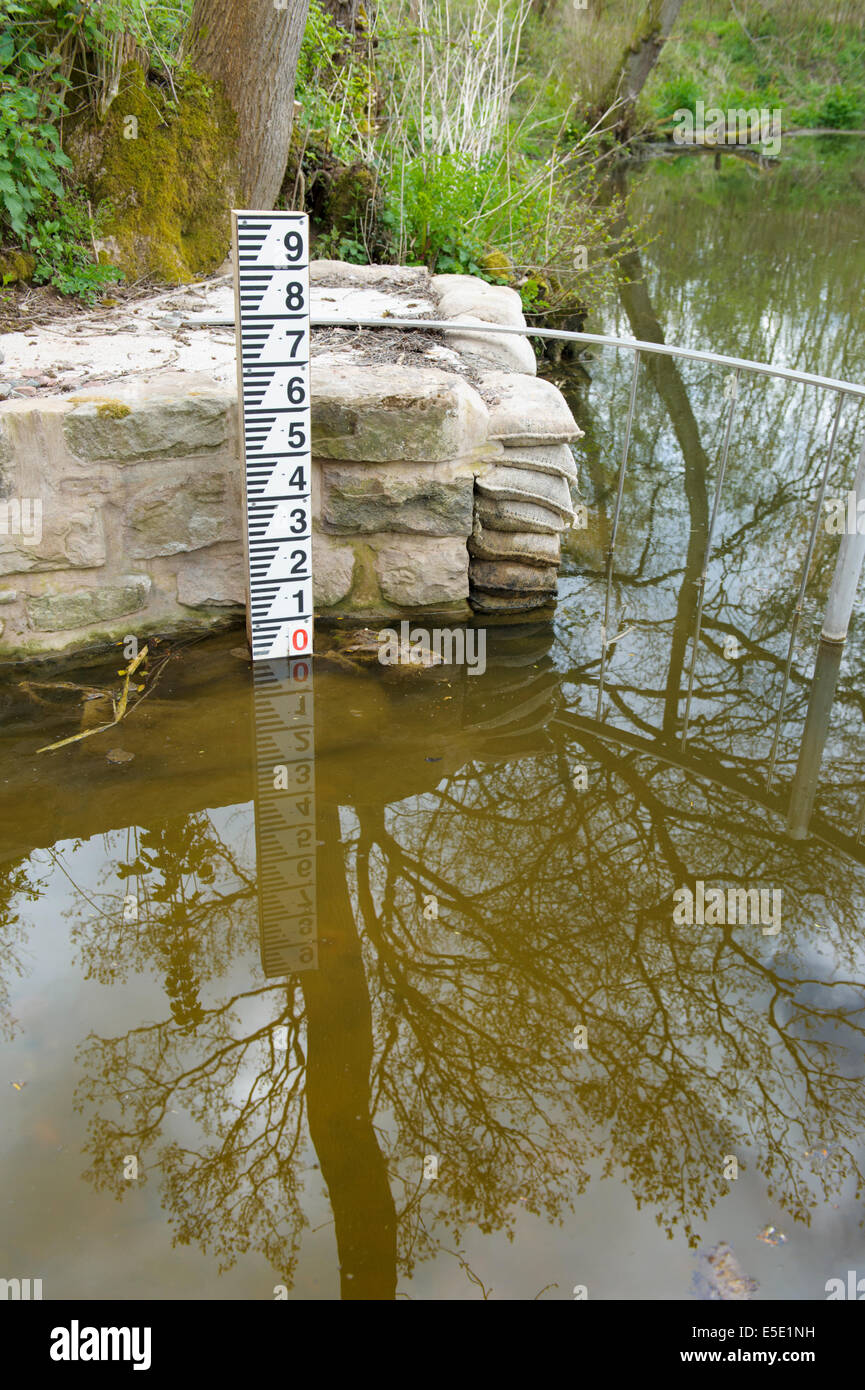 Lake overflow conduit with water level depth gauge Stock Photo - Alamy