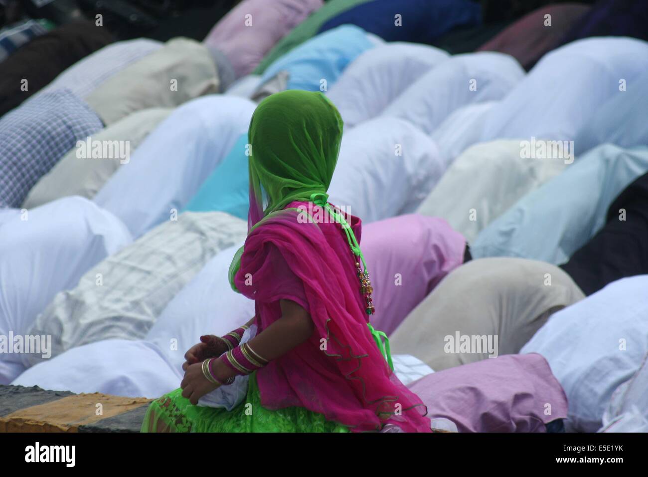 Varanasi, India. 29th July, 2014. A child looks at the Muslims offering ...