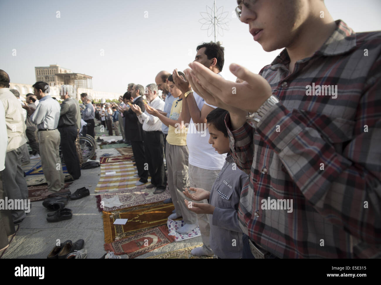 Isfahan, Iran. 29th July, 2014. Iranian men pray during an Eid al-Fitr ...