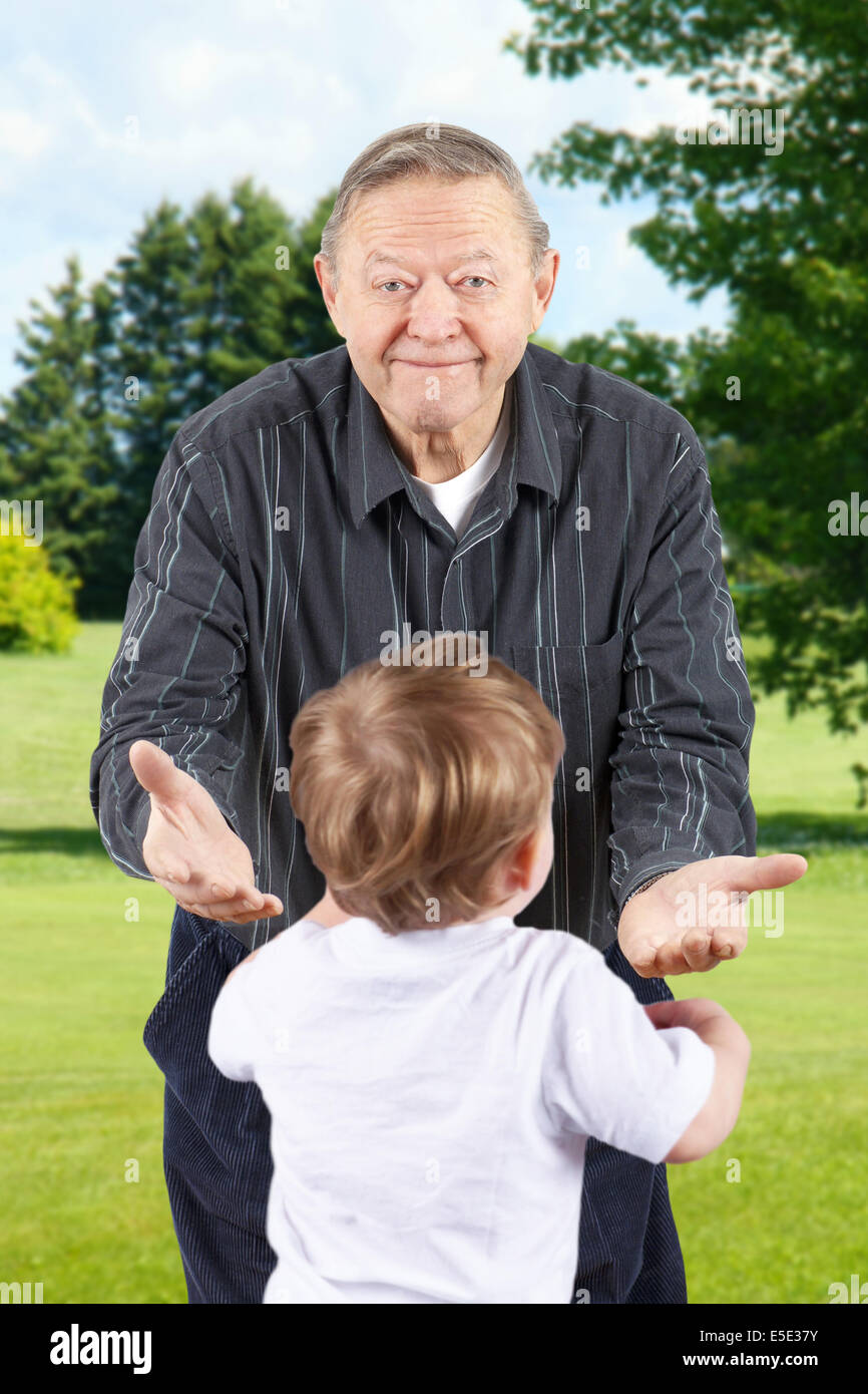 Happy senior man or grand father bending down with open arms to welcome ...