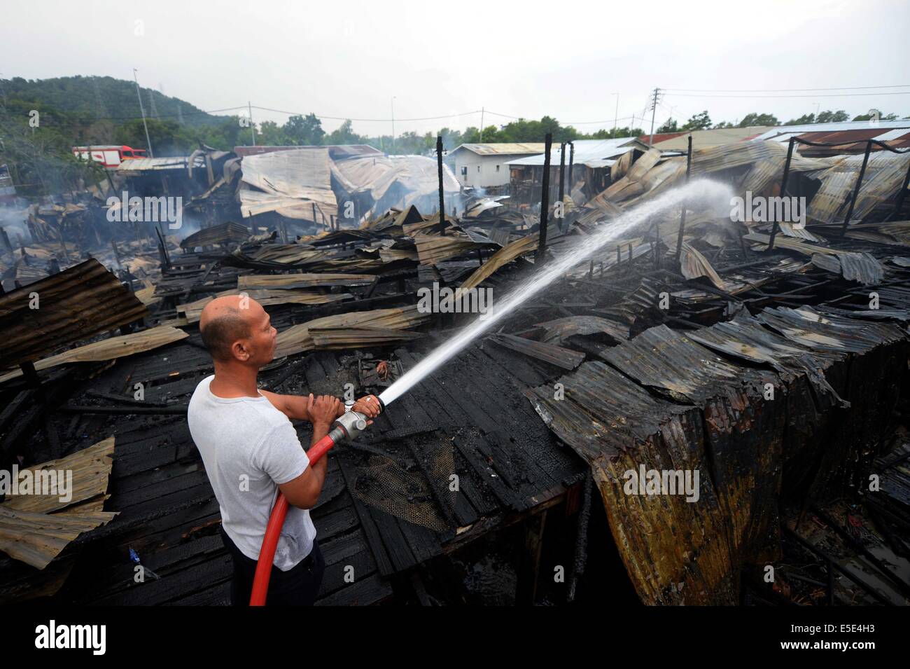 Sabah. 29th July, 2014. Photo taken on July 29, 2014 shows a man trying ...