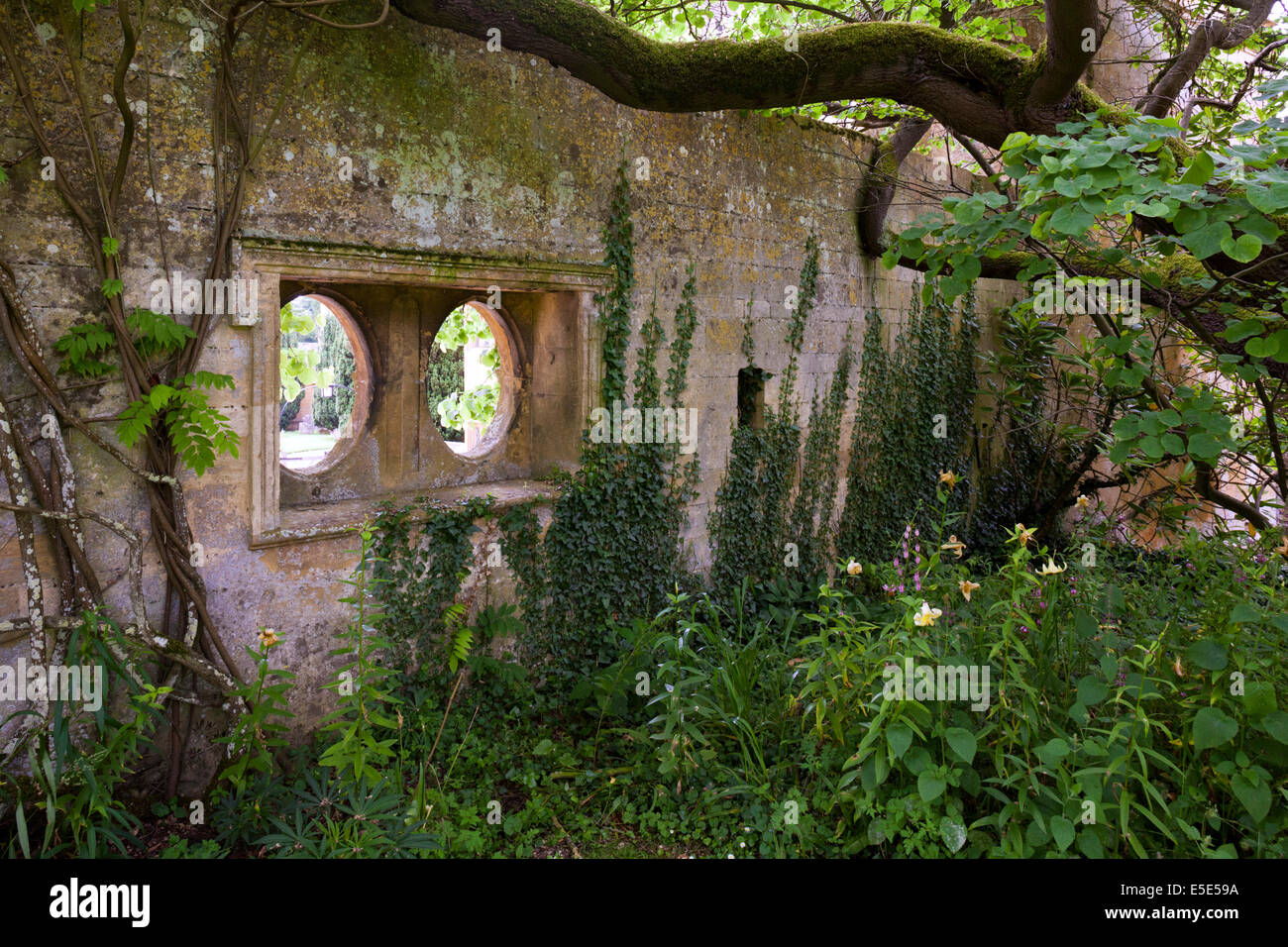 One of the three pairs of oval, spectacle-like windows in the garden ...