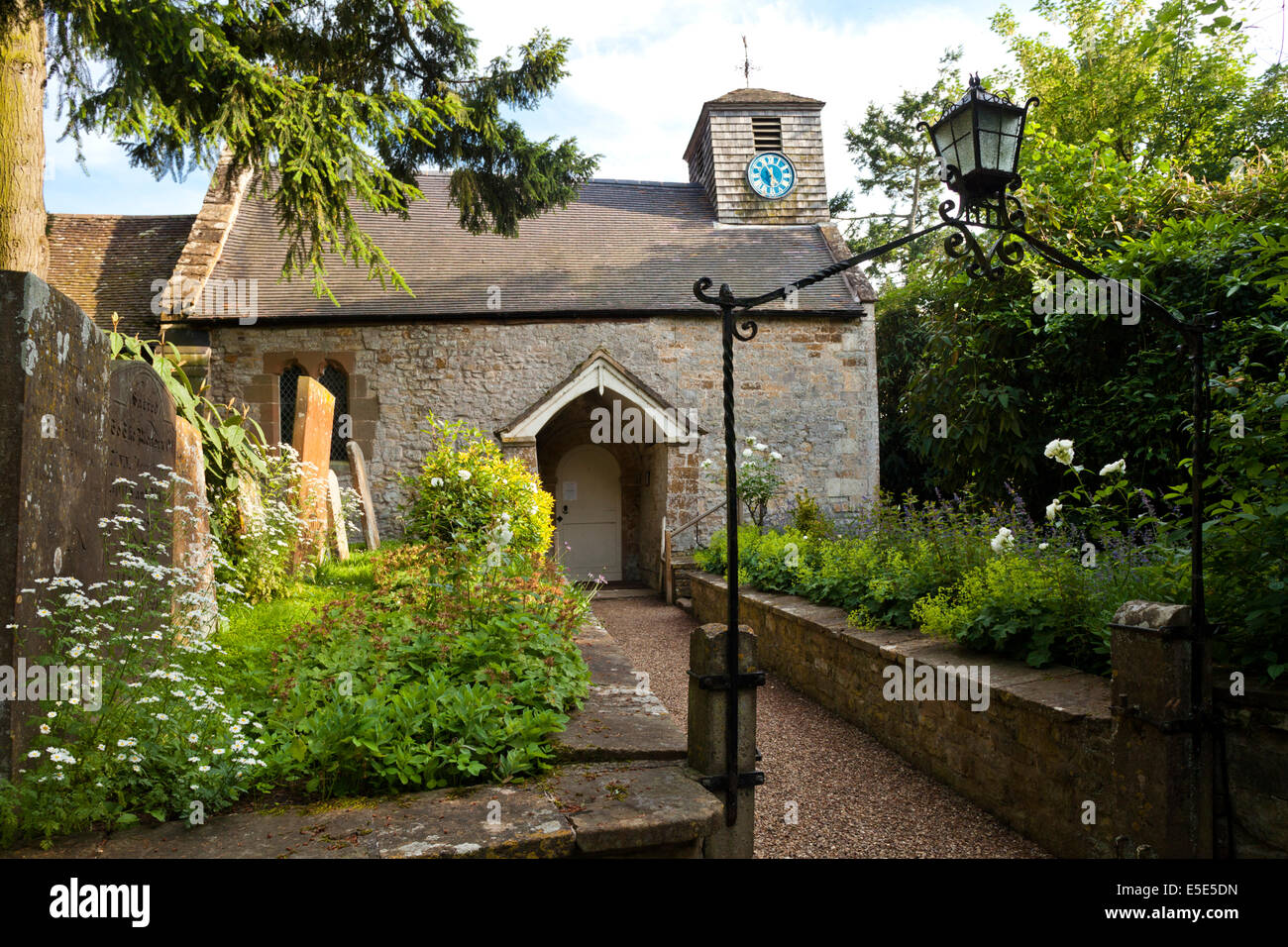 Evening light falling on the tiny Early English church of St James at ...