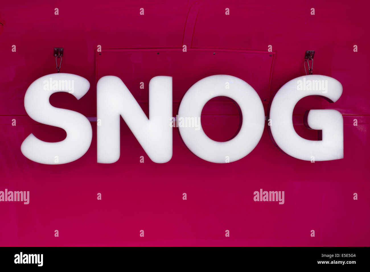 Bight illuminated SNOG logo sign. Hanging on a novelty double decker ...