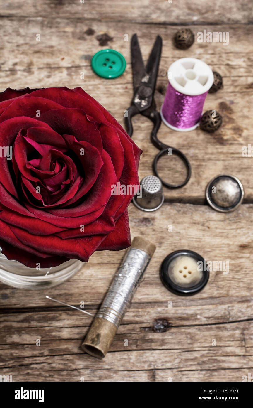 composition with red rose and sewing accessories and tools Stock Photo ...