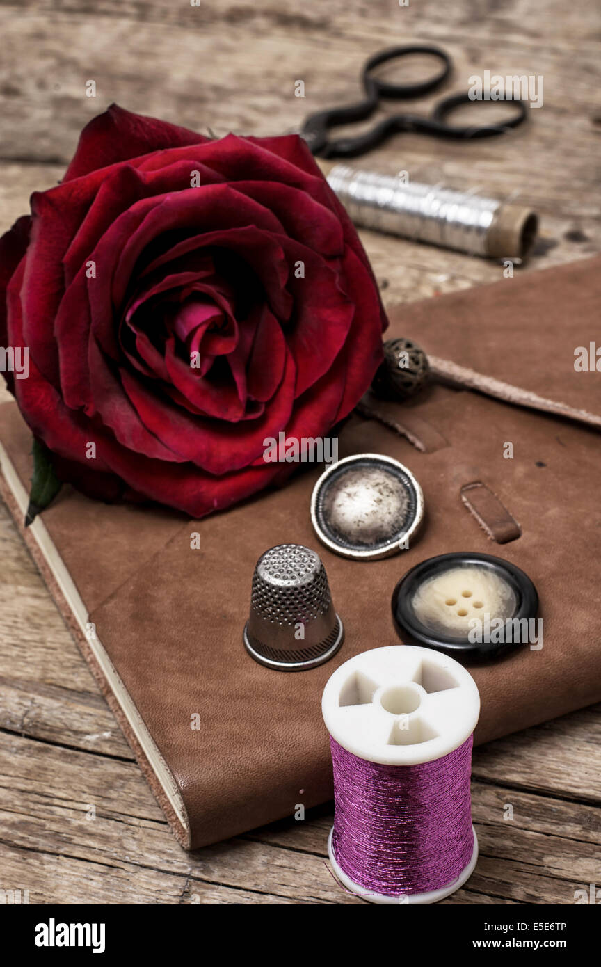 composition with red rose and sewing accessories and tools Stock Photo ...