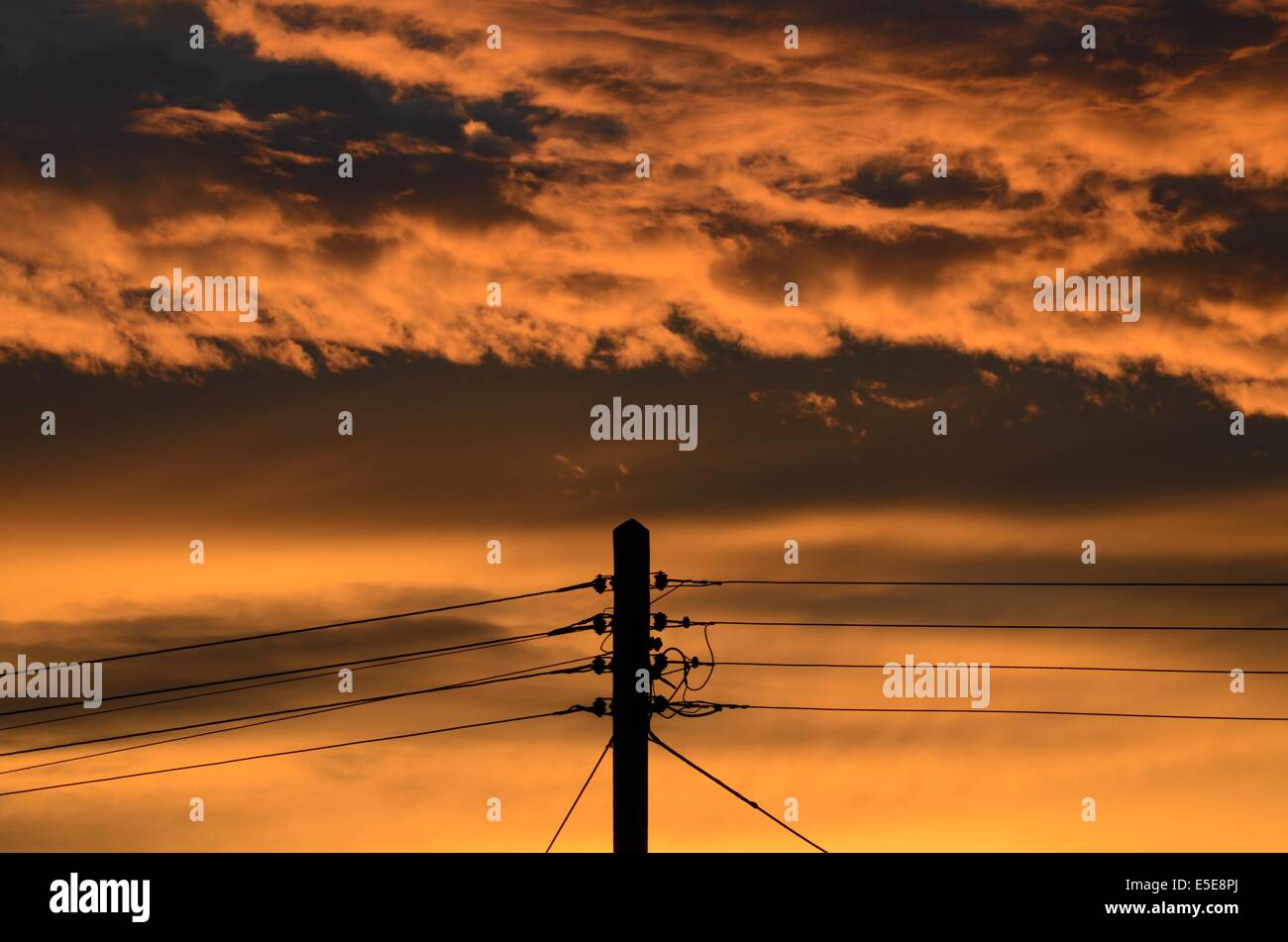 Silhouetted Power Lines Against Dramatic Sunset Clouds Stock Photo - Alamy