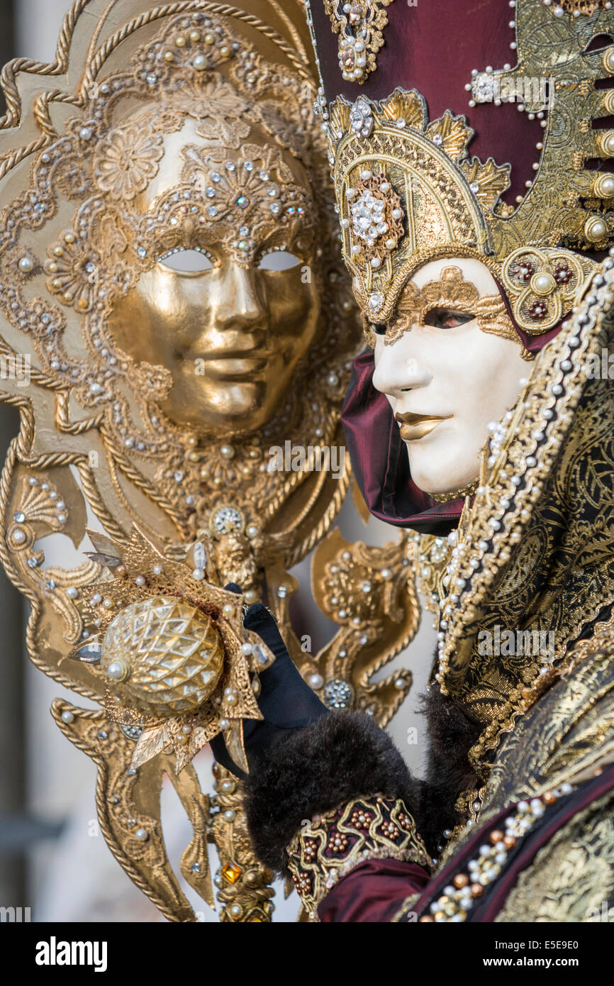 Man in black and gold elaborate Carnival costume carrying life sized ...