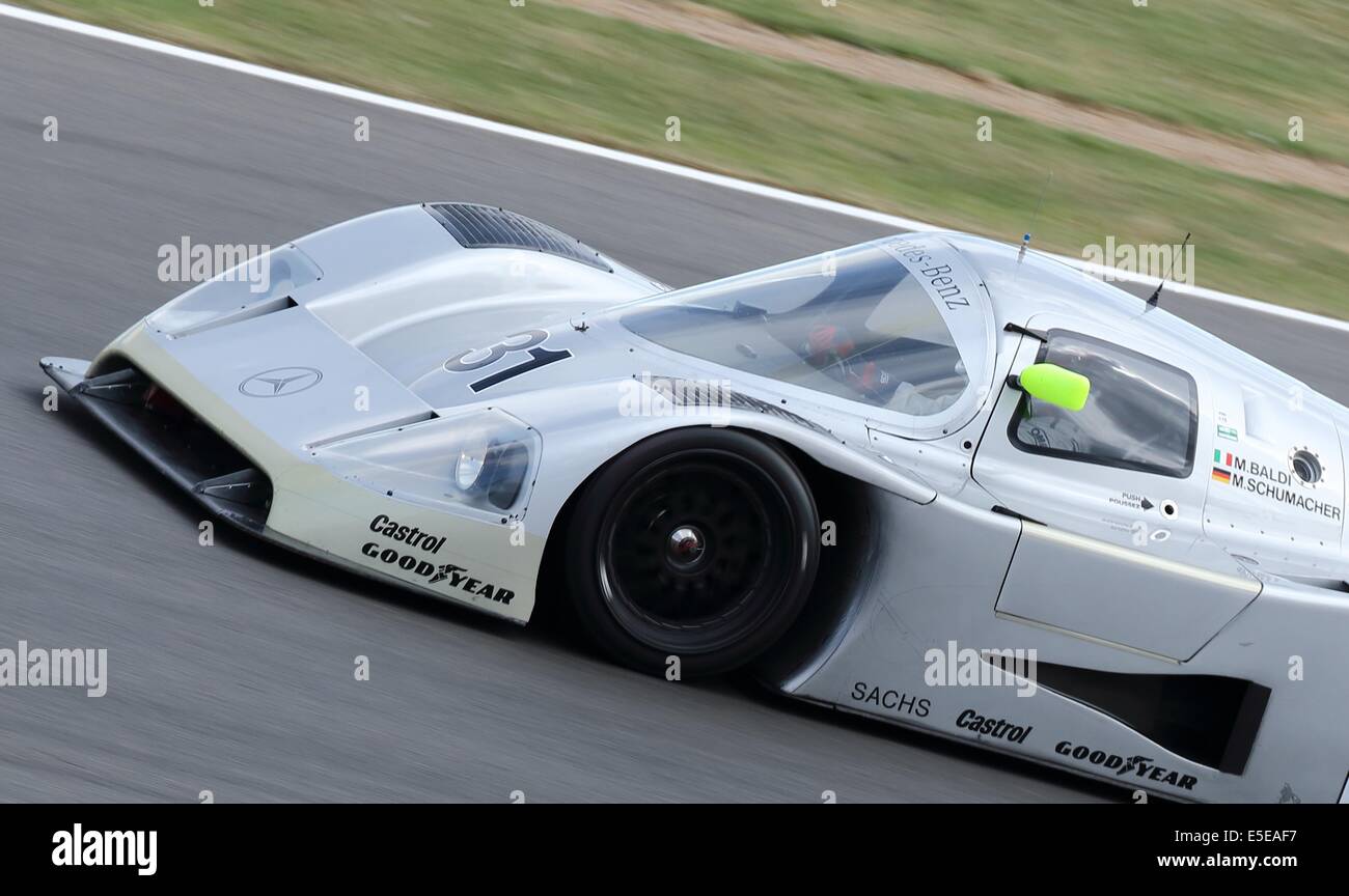 A silver Mercedes GT sports car racing at the Silverstone Classic, July ...