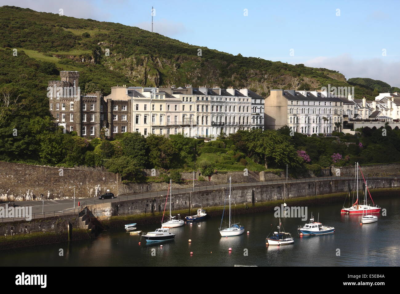 A terrace of Victorian houses overlooking boats moored at the mouth of ...