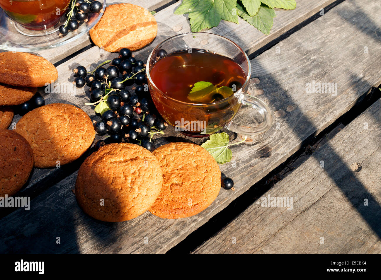 blackcurrant tea with currant leaves and berries in teacup, with ...