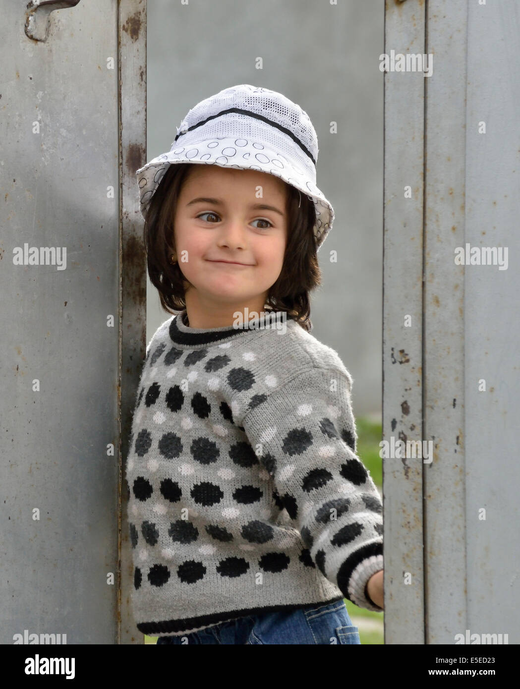 Young girl by the gate to her home, village of Lahic, Azerbaijan Stock ...