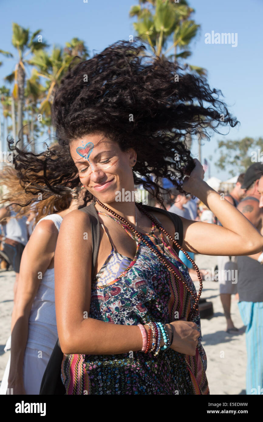 Young woman dancing at a music festival at the beach in Long Beach, CA ...