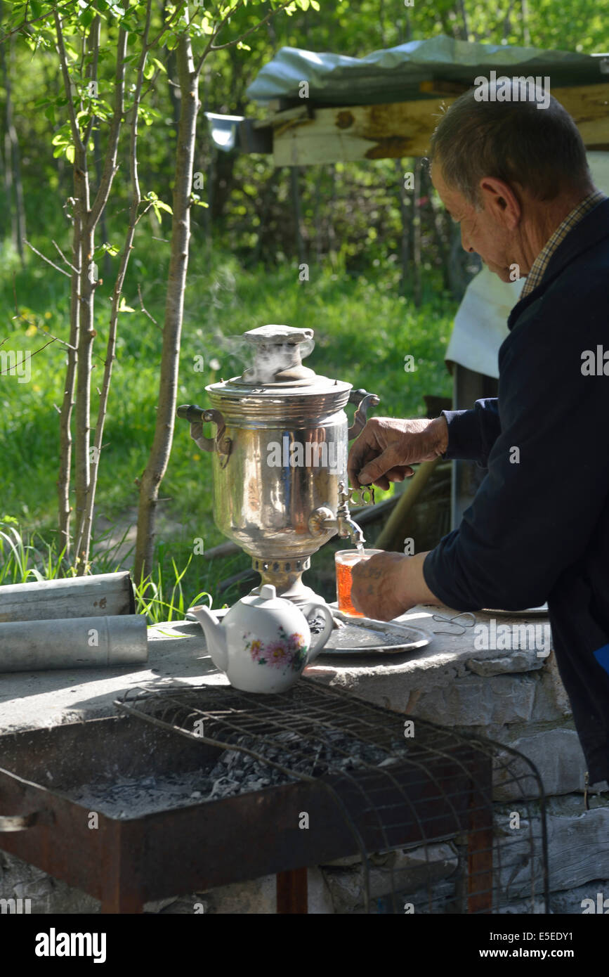 Man making tea with samovar, village of Lahic, Caucasus region ...
