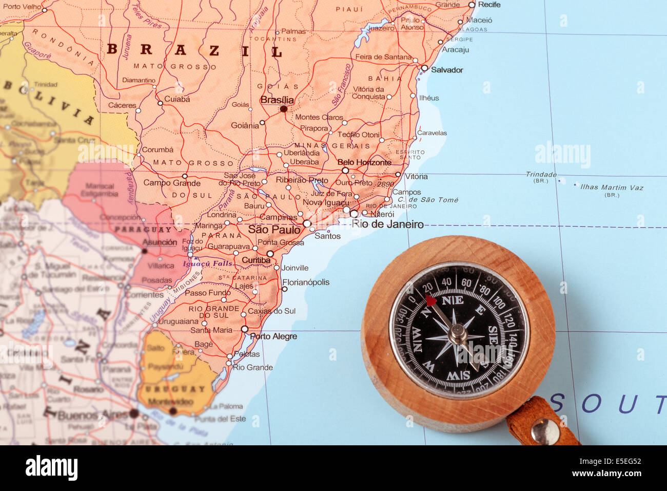 Compass on a map pointing at Brazil and planning a travel destination ...