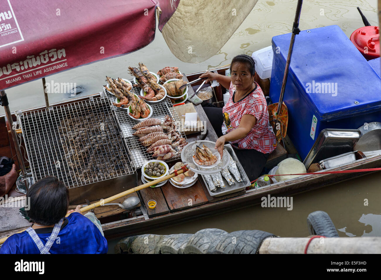 traditional boat vendor selling shrimp at the Amphawa Floating Market ...