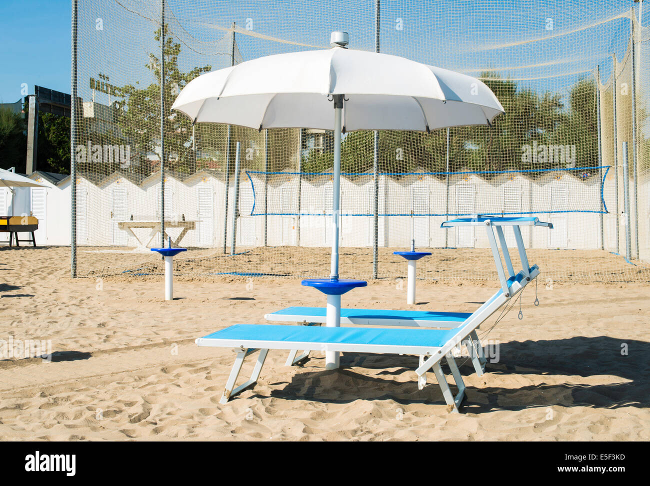 Blue sunbeds and umbrellas on the beach Stock Photo - Alamy