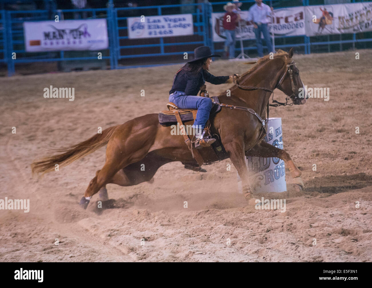 Cowgirl Participating in a Barrel racing competition at the Helldorado ...