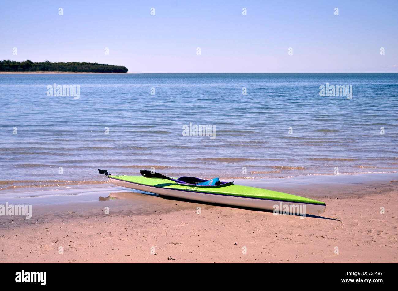 Canoe on the edge of a beach Stock Photo - Alamy