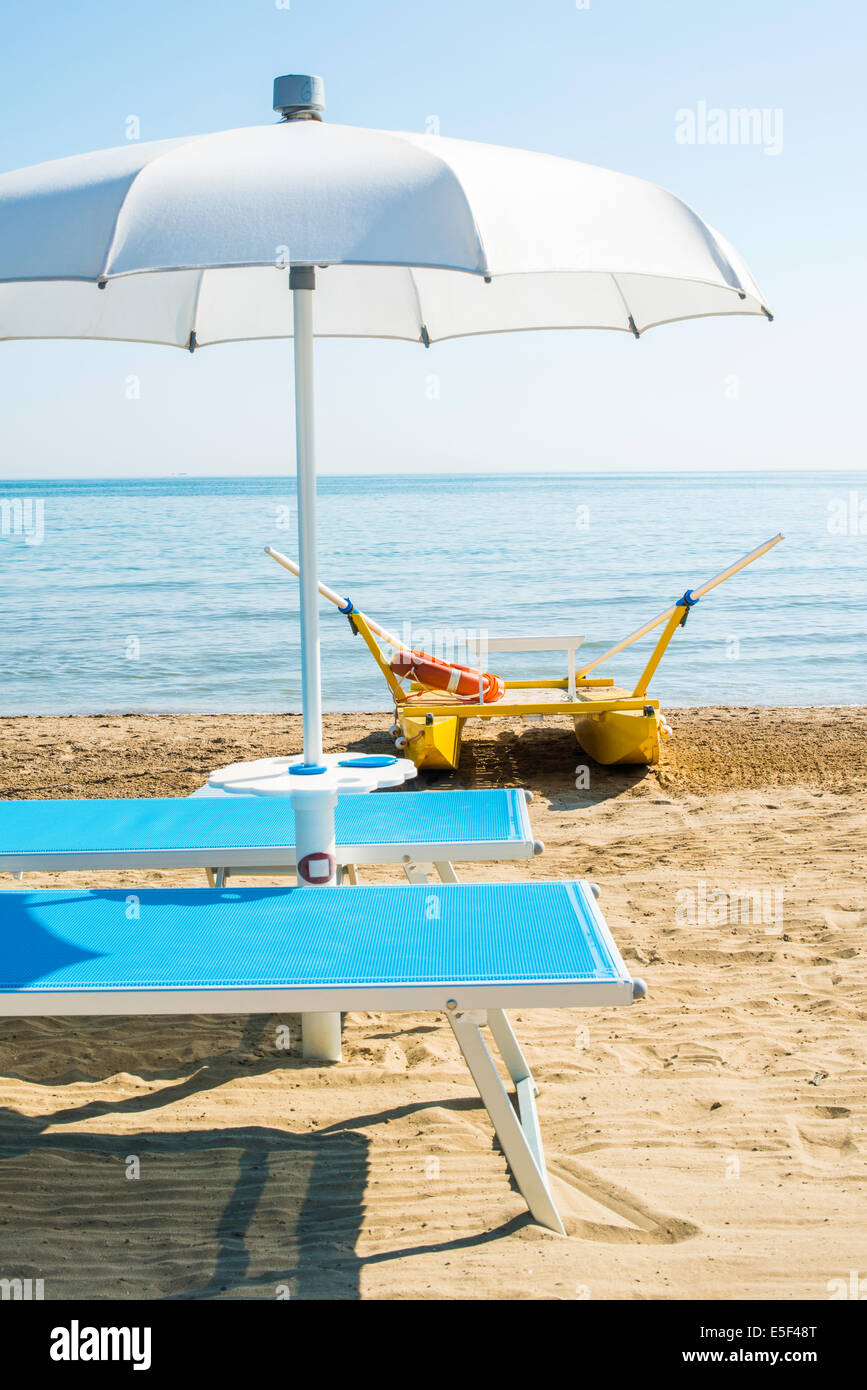Blue sunbeds and umbrellas on the beach Stock Photo - Alamy