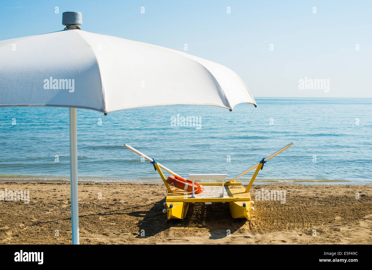 Yellow lifeboat on the beach. Italian beach Stock Photo - Alamy