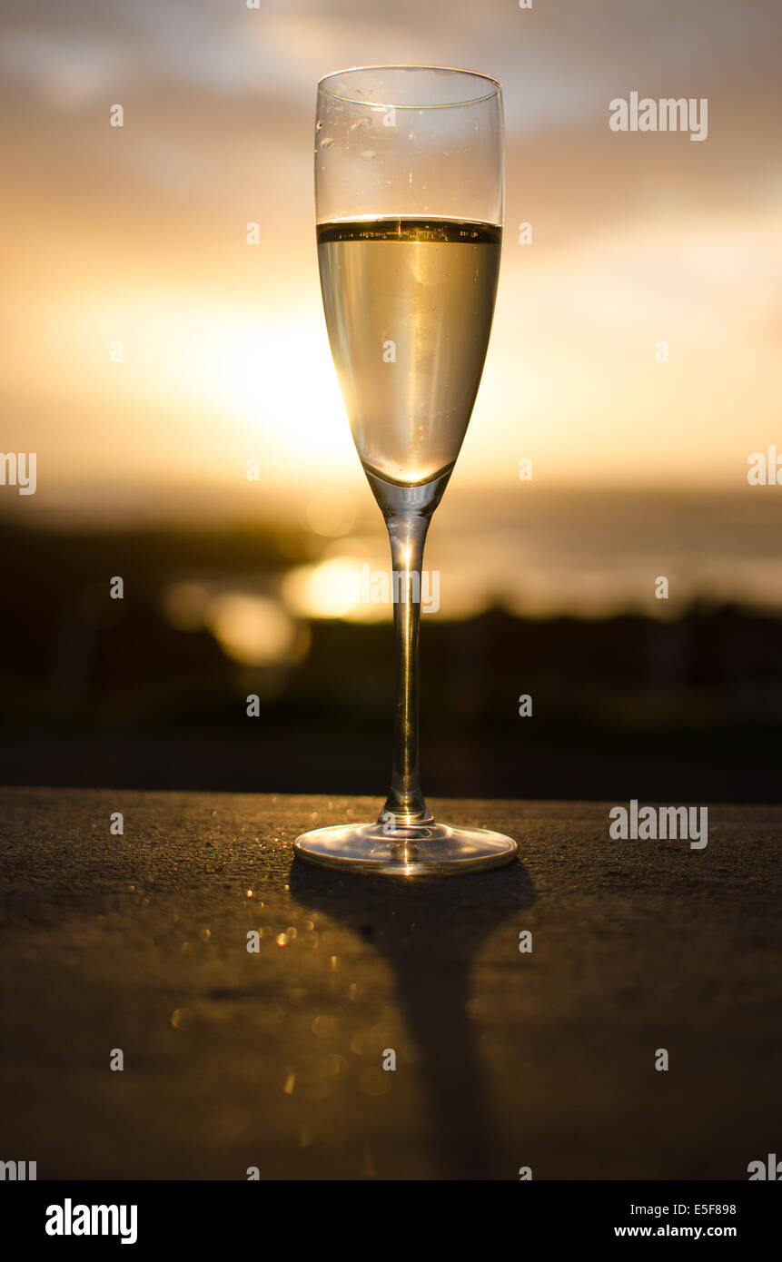 A glass of champagne at sunset Stock Photo - Alamy