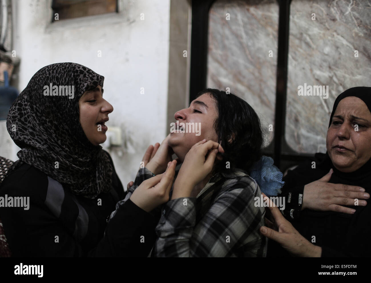 Relatives of Palestinians Samir and Basheer Hajjar mourn during their ...