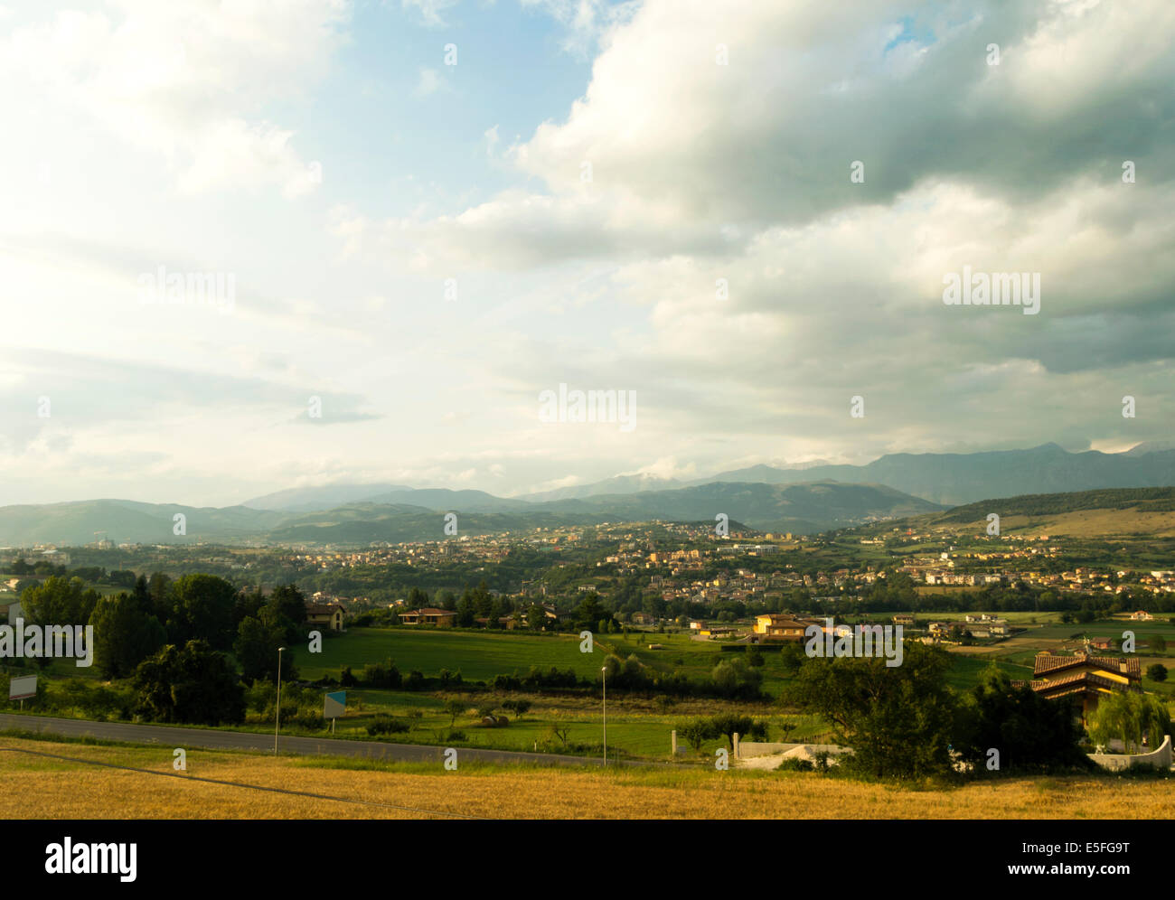 beautiful mountain landscape, town and cloudy sky Stock Photo - Alamy
