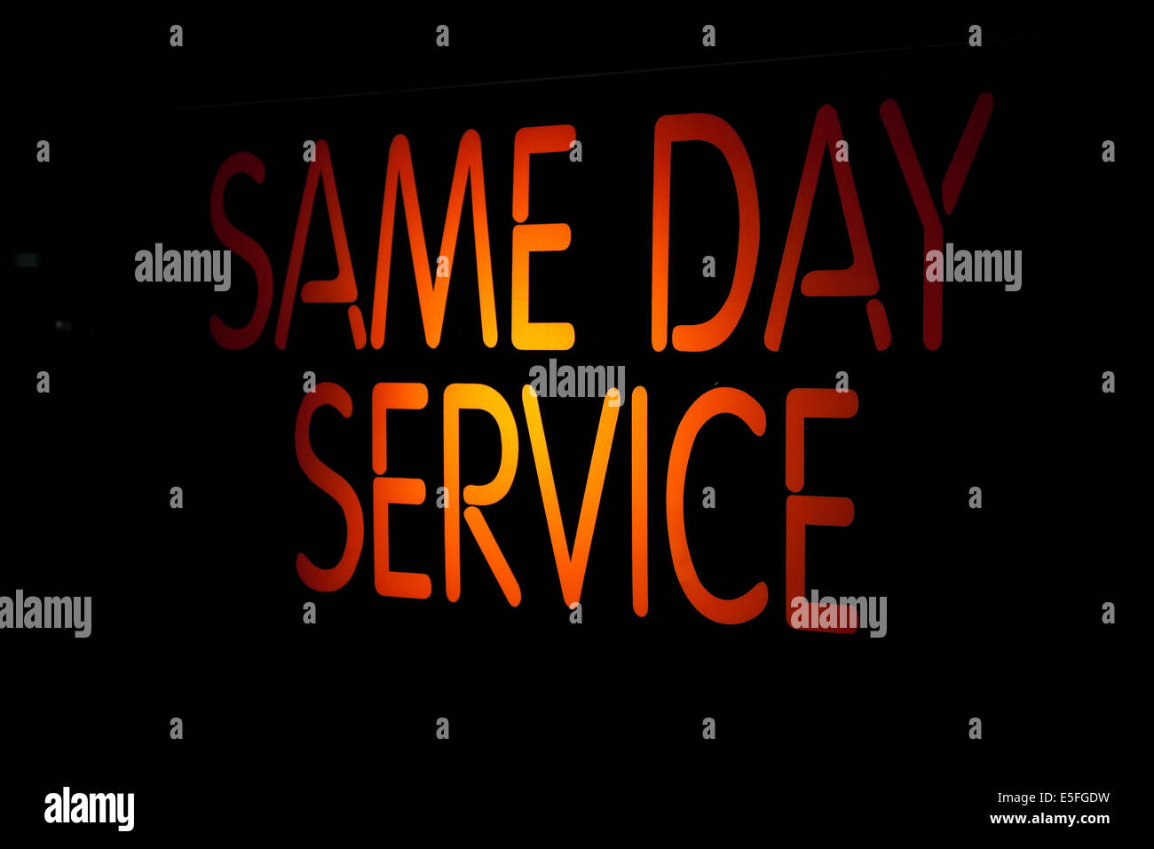 Neon Sign Same Day Service on Black Background Stock Photo - Alamy