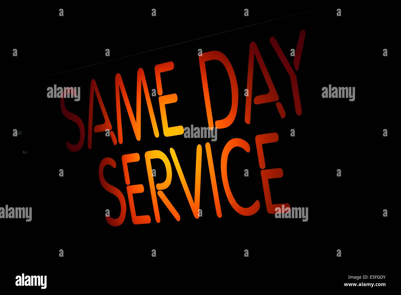 Neon Sign Same Day Service on Black Background Stock Photo - Alamy